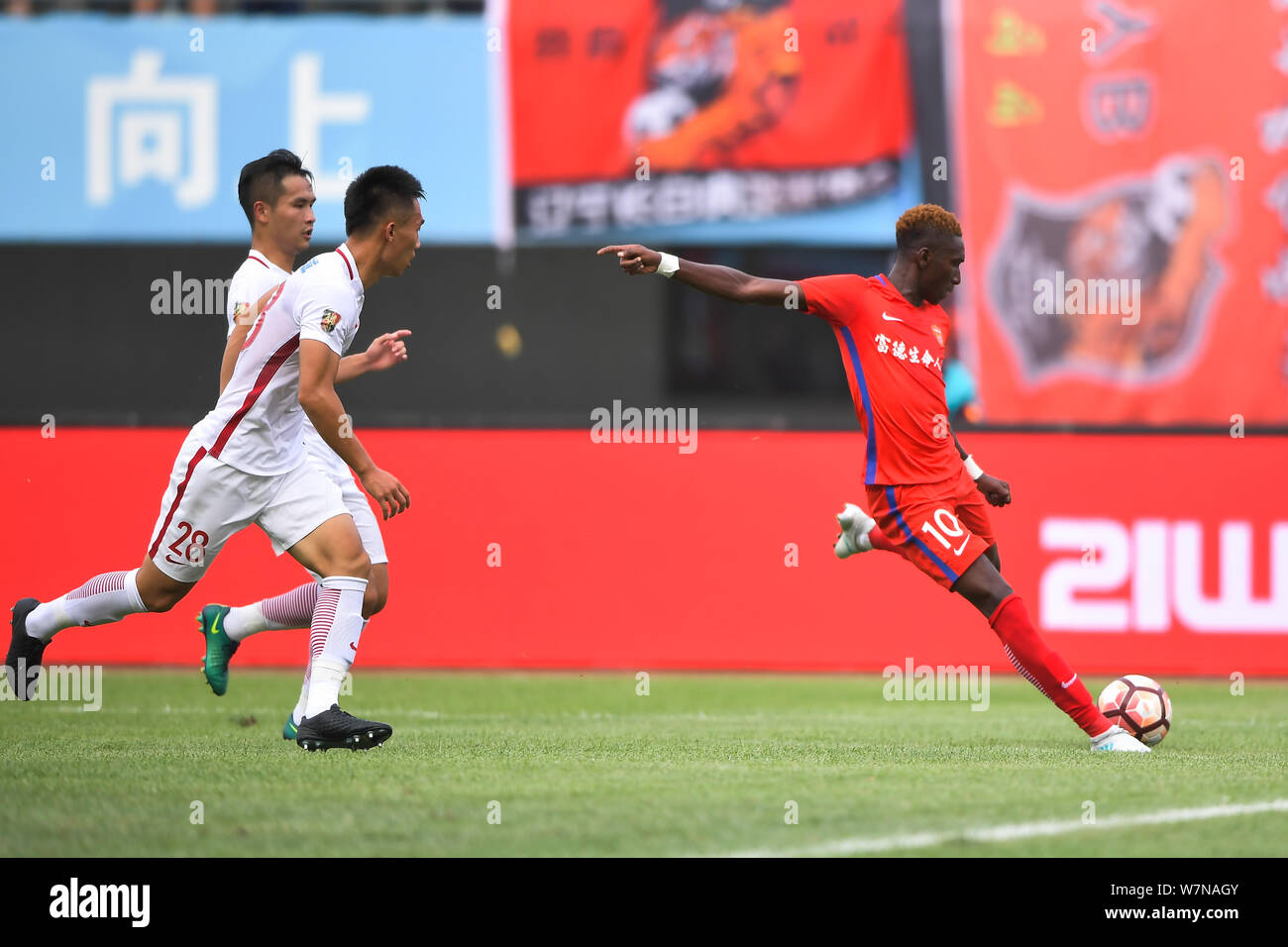 Gambian football player Bubacarr Trawally, right, of Yanbian Funde ...