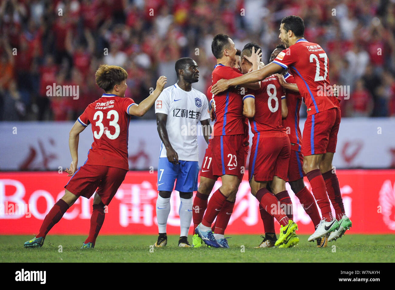 Players of Chongqing Lifan celebrate after scoring a goal against ...
