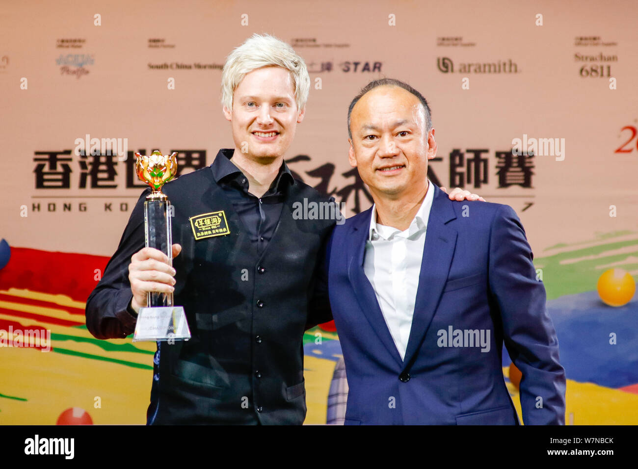 Neil Robertson, left, of Australia, poses with his trophy during the ...
