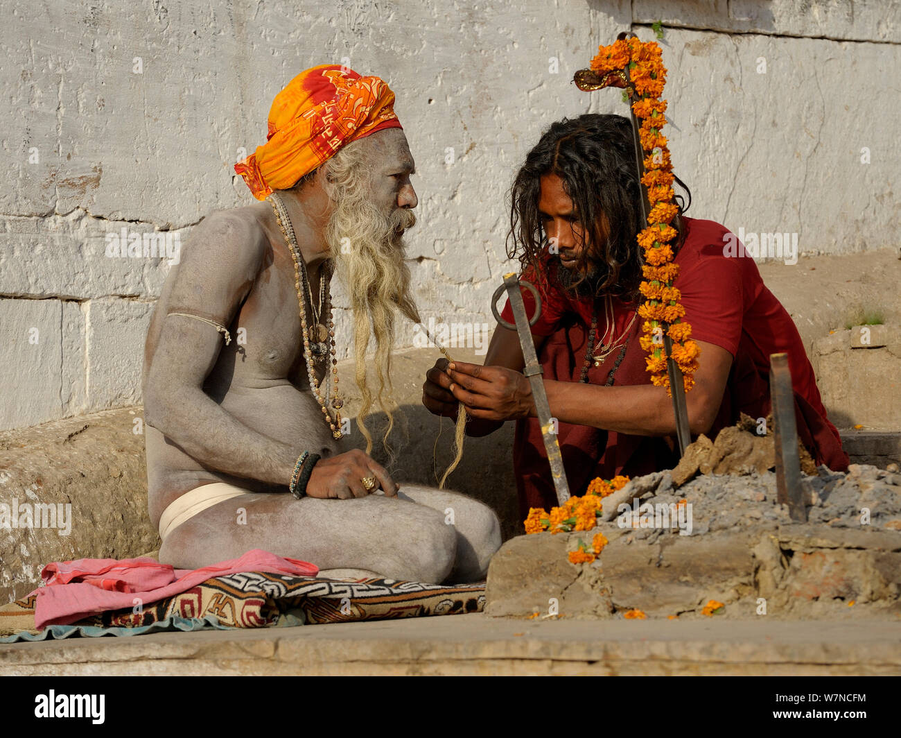Shadus, holy men, sitting on the famous ghats of the Ganges river ...
