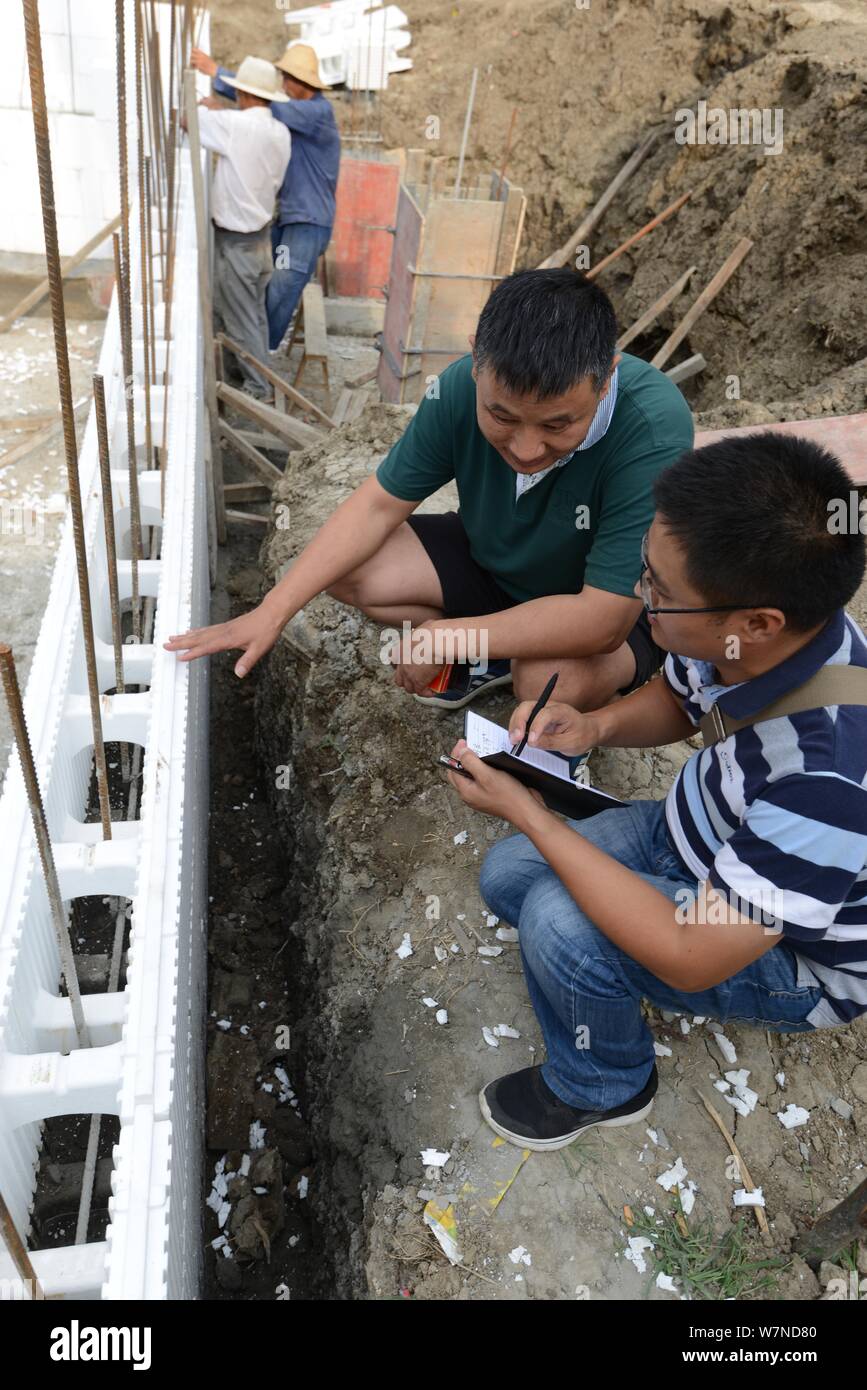 --FILE--Chinese workers build a house with molded expanded polystyrene ...