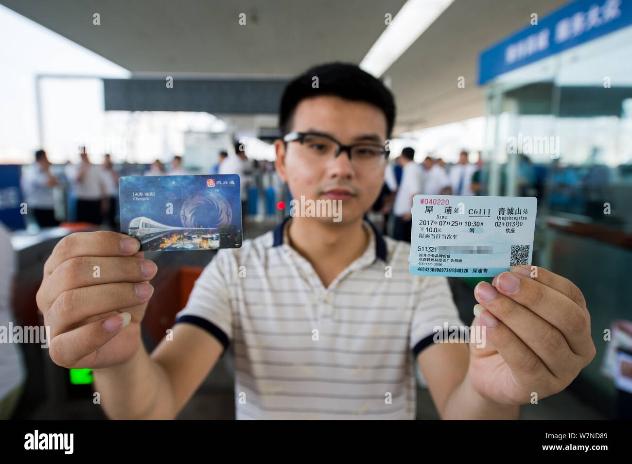 A passenger shows his Metro line 2's ticket (left) and high-speed ...
