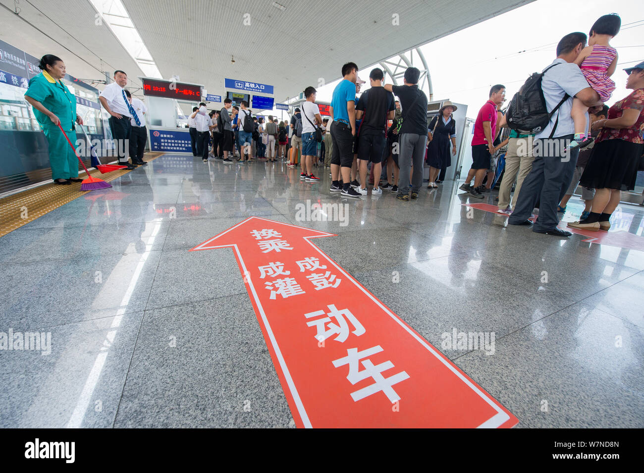 Passengers queue up to buy train tickets to transfer to a high-speed ...