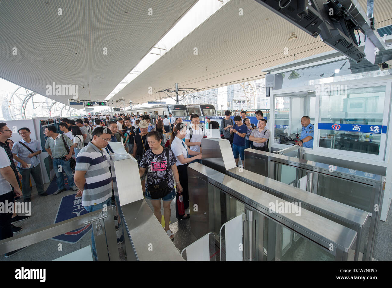 Passengers are pictured to have their train tickets automatically ...