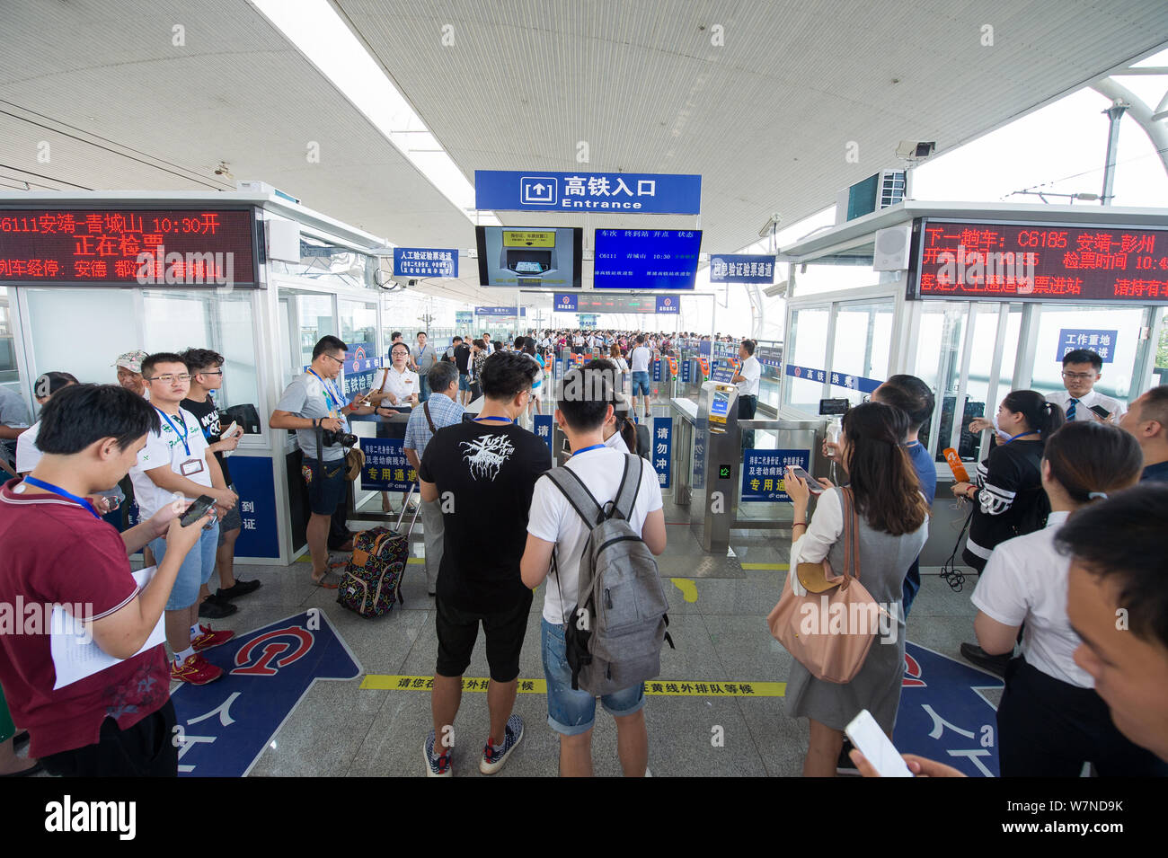 Passengers are pictured to have their train tickets automatically ...