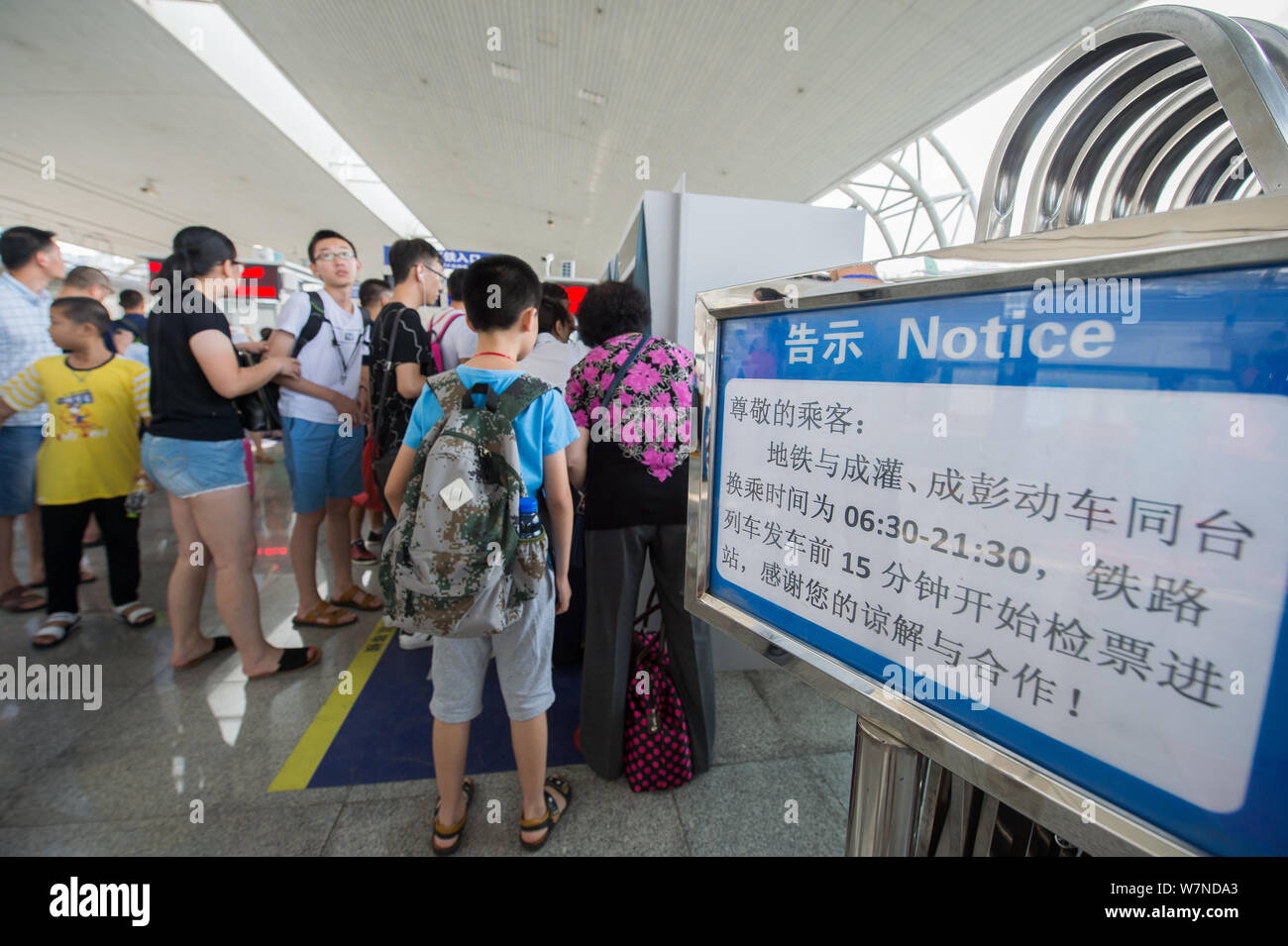 Passengers queue up to buy train tickets to transfer to a high-speed ...