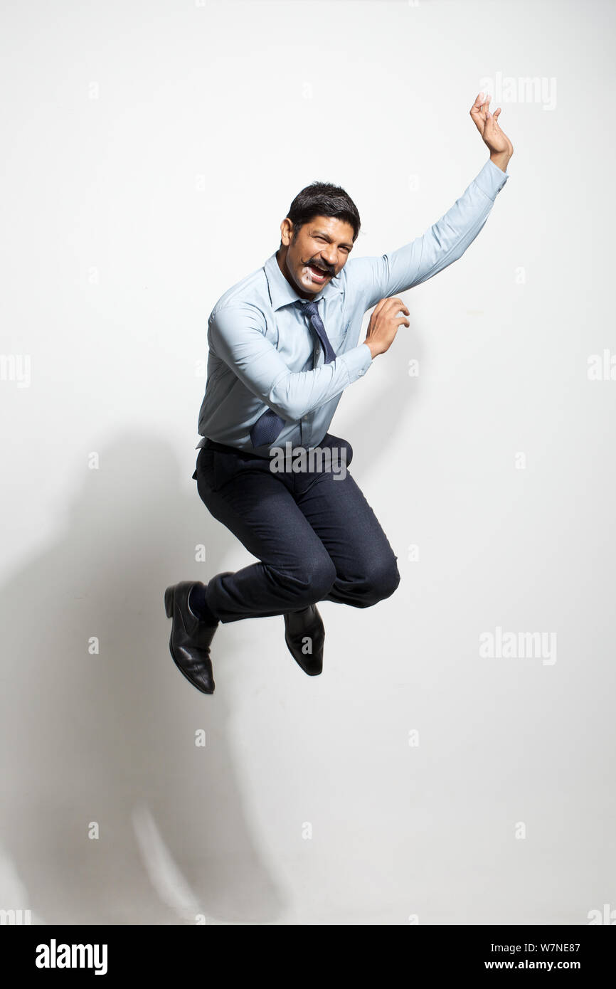 Businessman jumping in air Stock Photo - Alamy