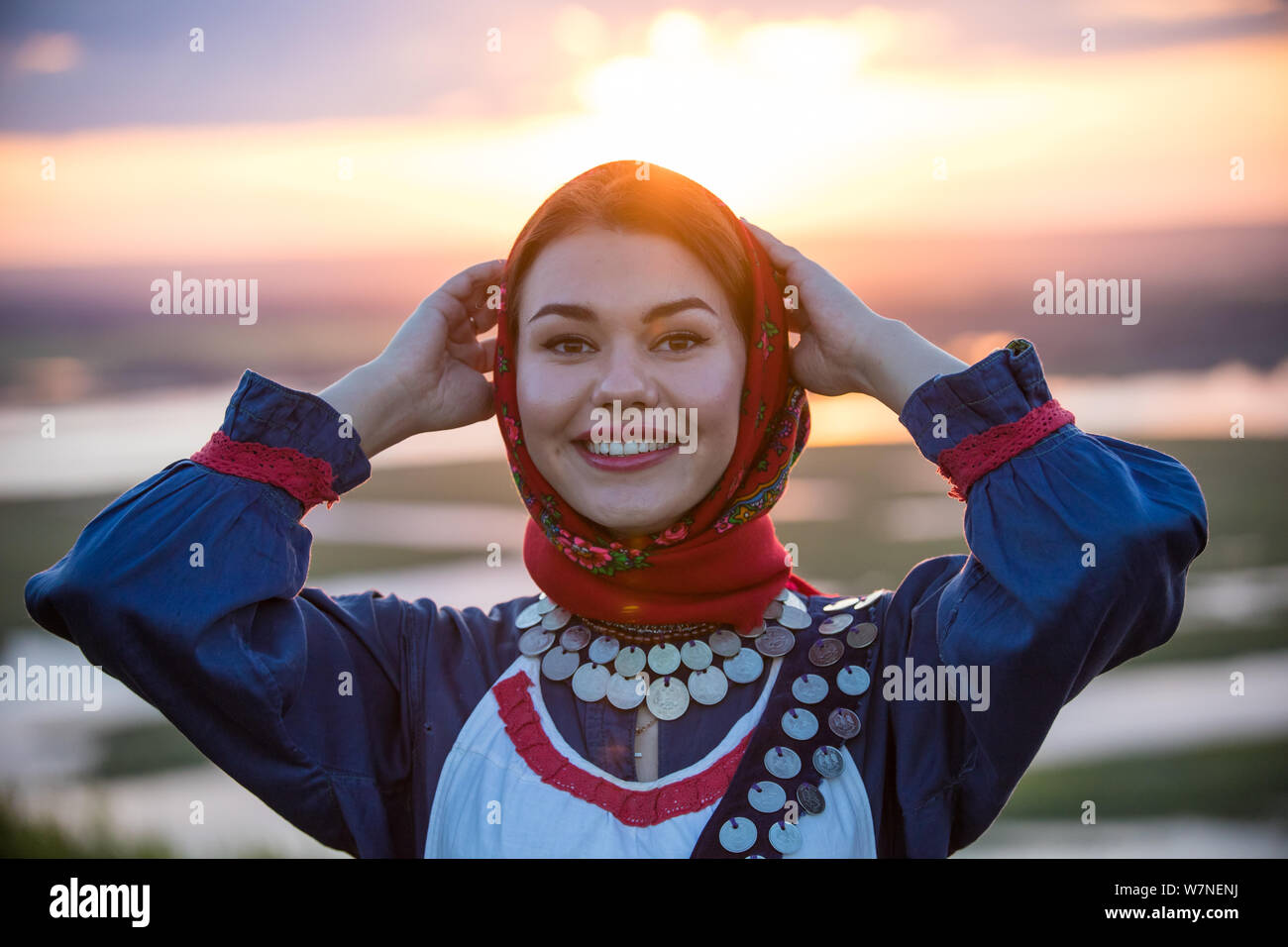 Young smiling woman in traditional russian clothes on a background of ...
