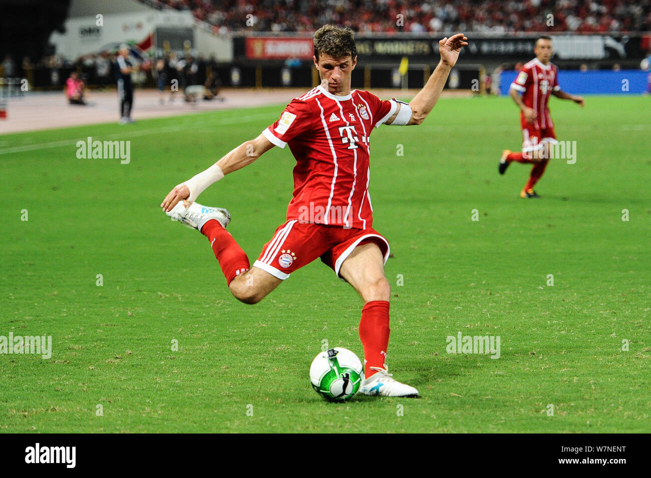 Thomas Muller of Bayern Munich kicks the ball to shoot against Arsenal during the Shanghai match ...