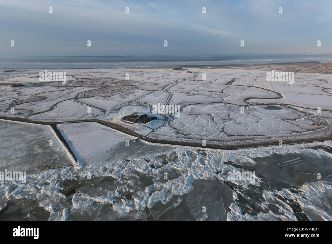 Aerial view of Hallig Island Nordstrandischmoor, in winter with snow ...
