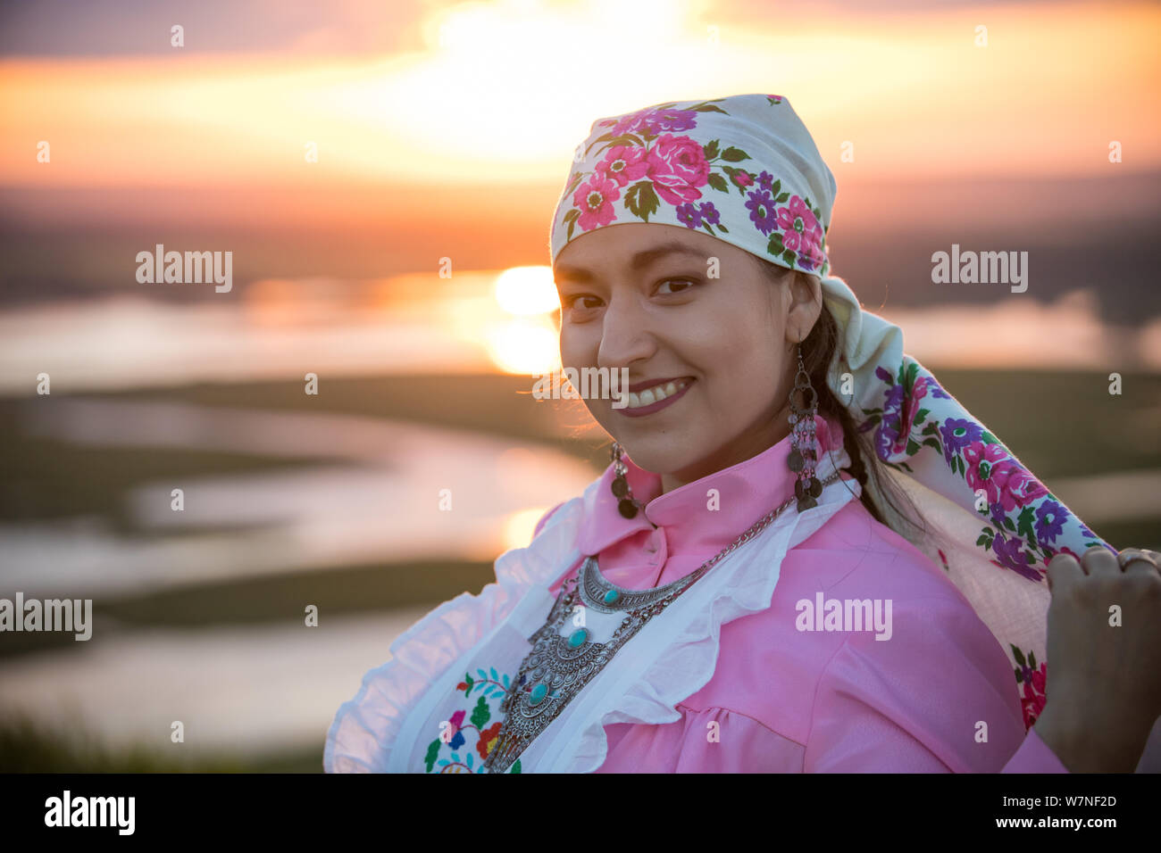 A smiling woman in traditional folk clothes on a background of the ...