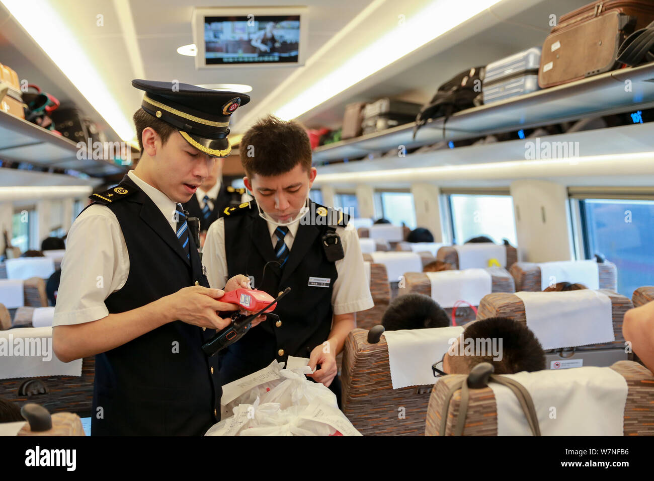 Railway staff deliver the meal to the seat designated by the passenger ...