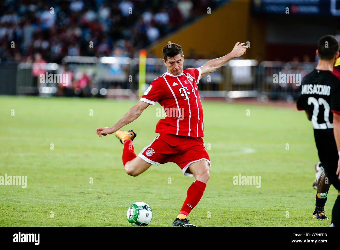 Robert Lewandowski of Bayern Munich kicks the ball to shoot against ...