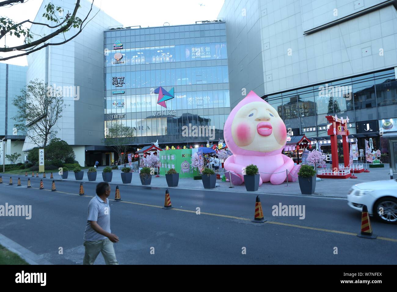 A pedestrian looks at a 6-meter-tall giant inflatable Kobitos, a ...