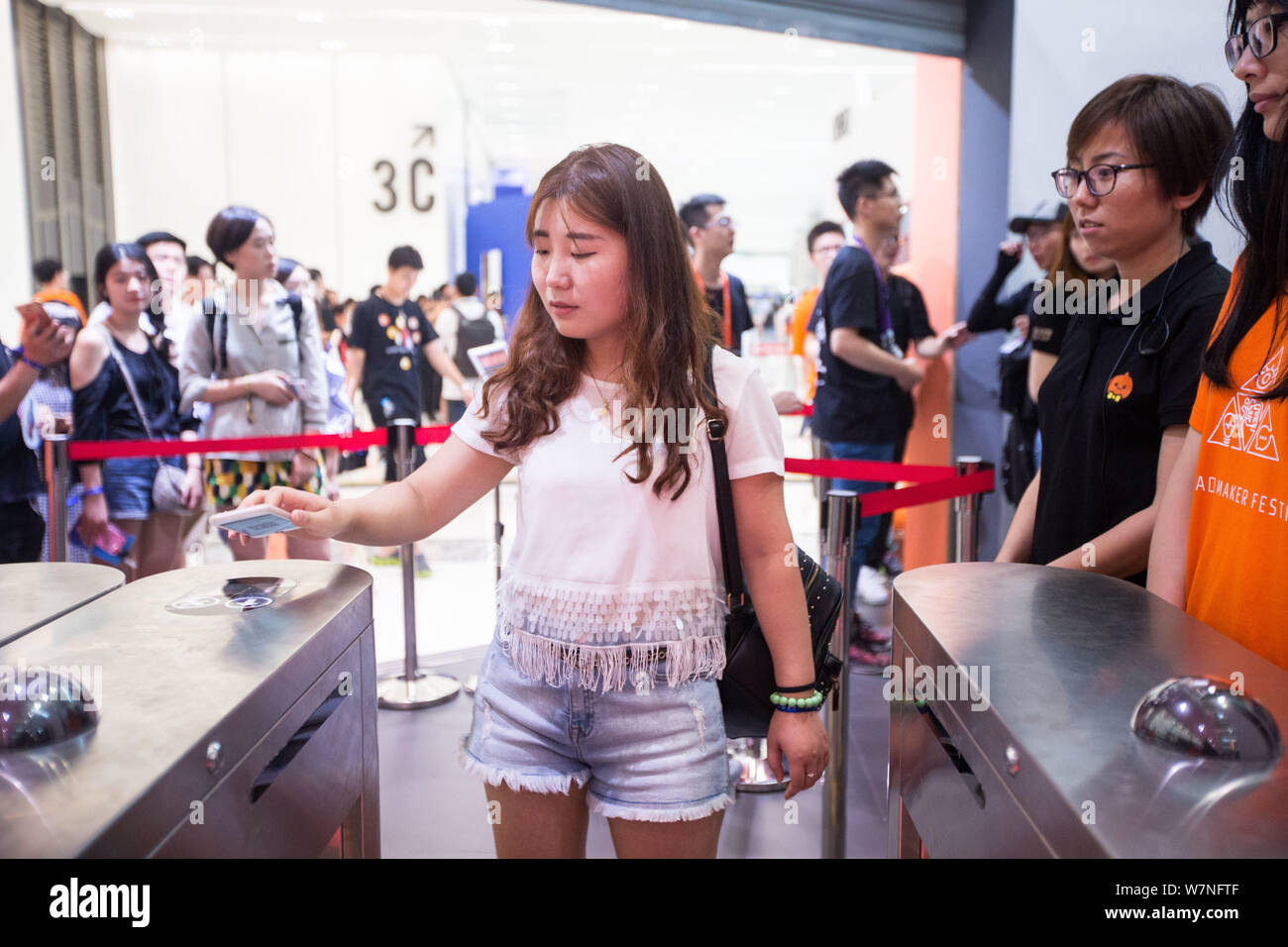 A customer scans the QR code to get an electronic entrance ticket of ...