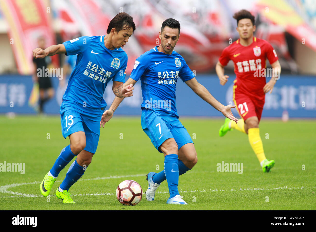 Israeli football player Eran Zahavi, right, of Guangzhou R&F kicks the ...