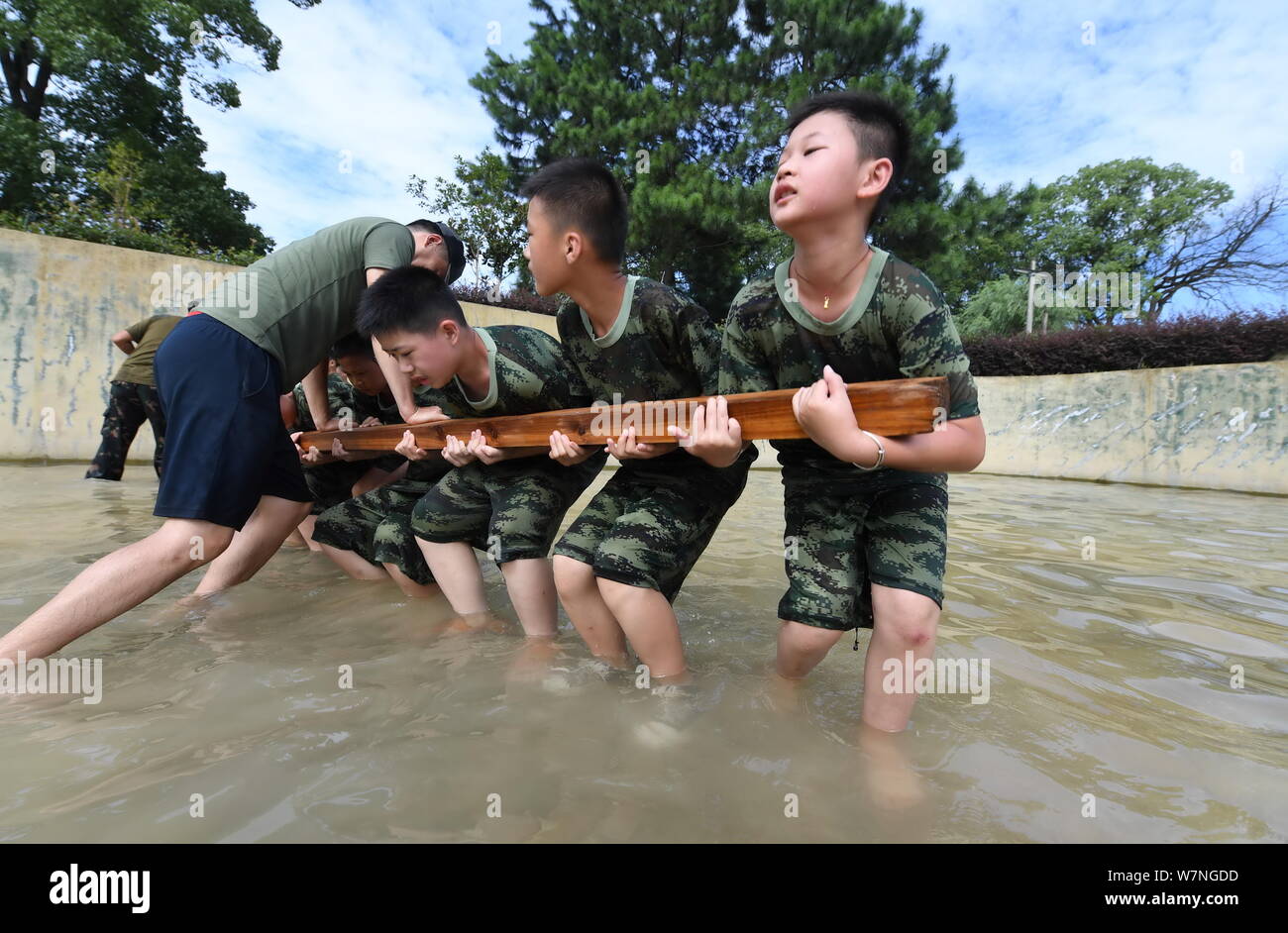 Chinese primary students practice during a summer camp for special force training in Xinyu city ...
