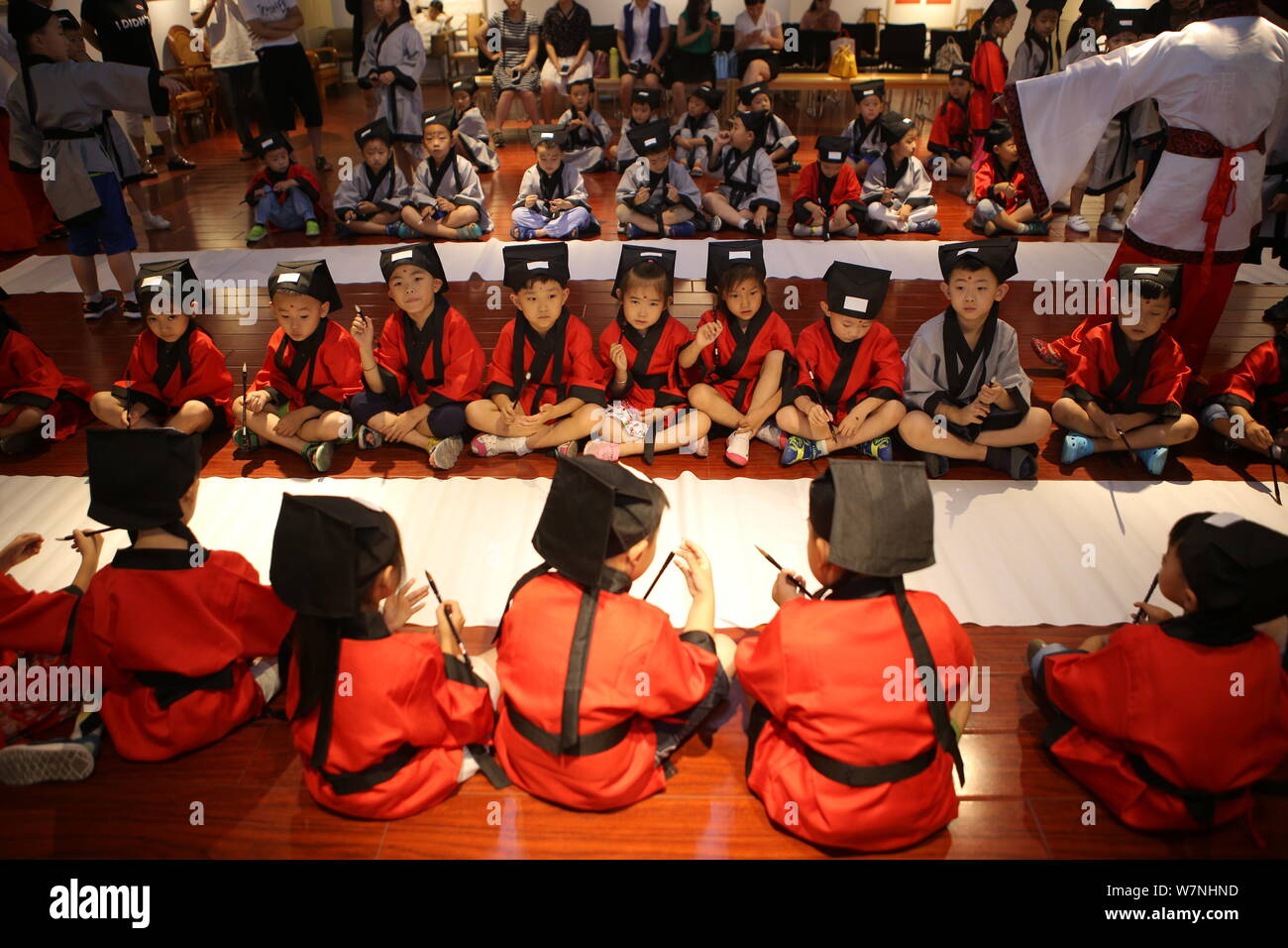 Students learn to write the Chinese character "Ren," meaning "Human" in ...