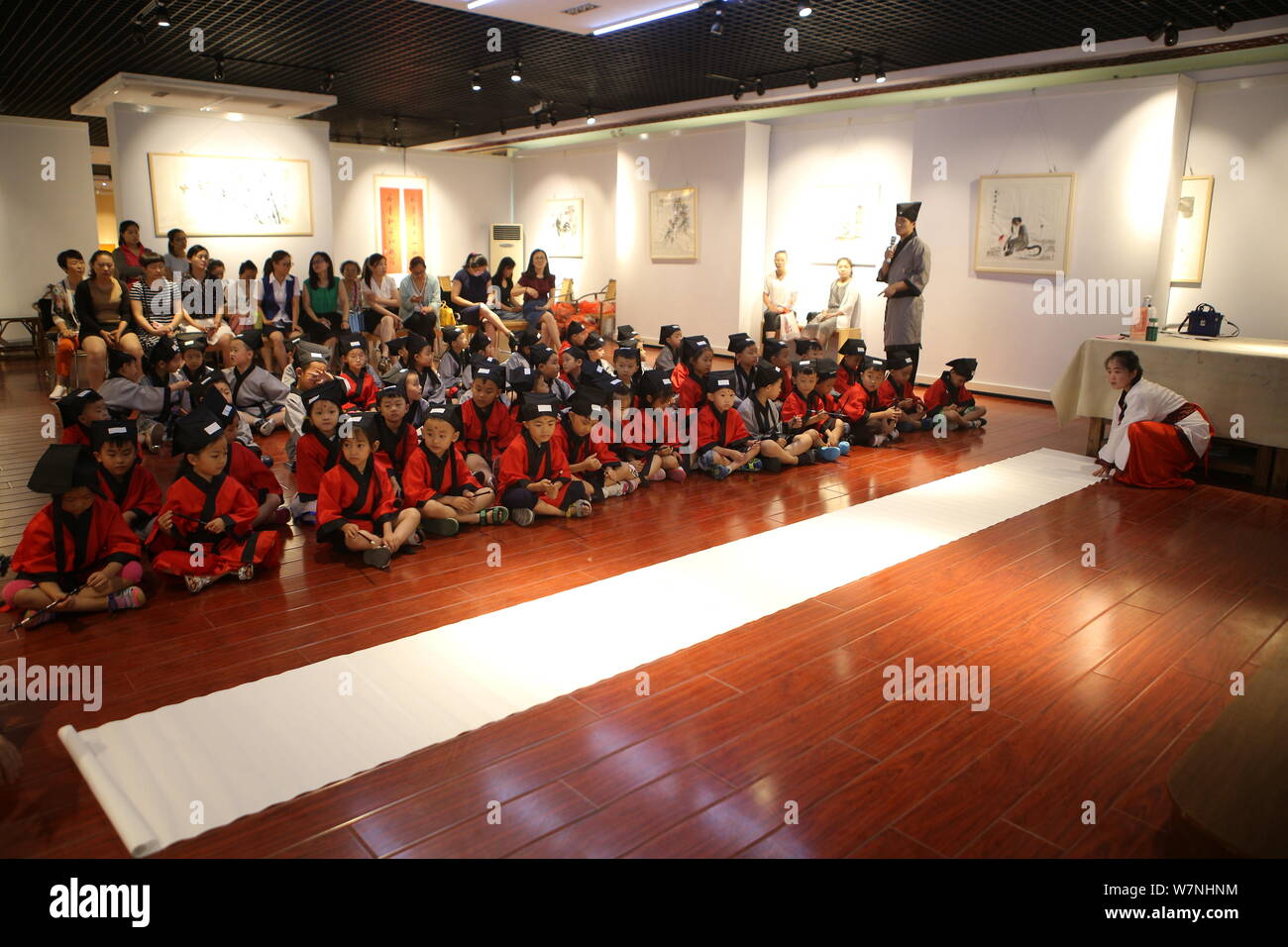 Students learn to write the Chinese character "Ren," meaning "Human" in ...