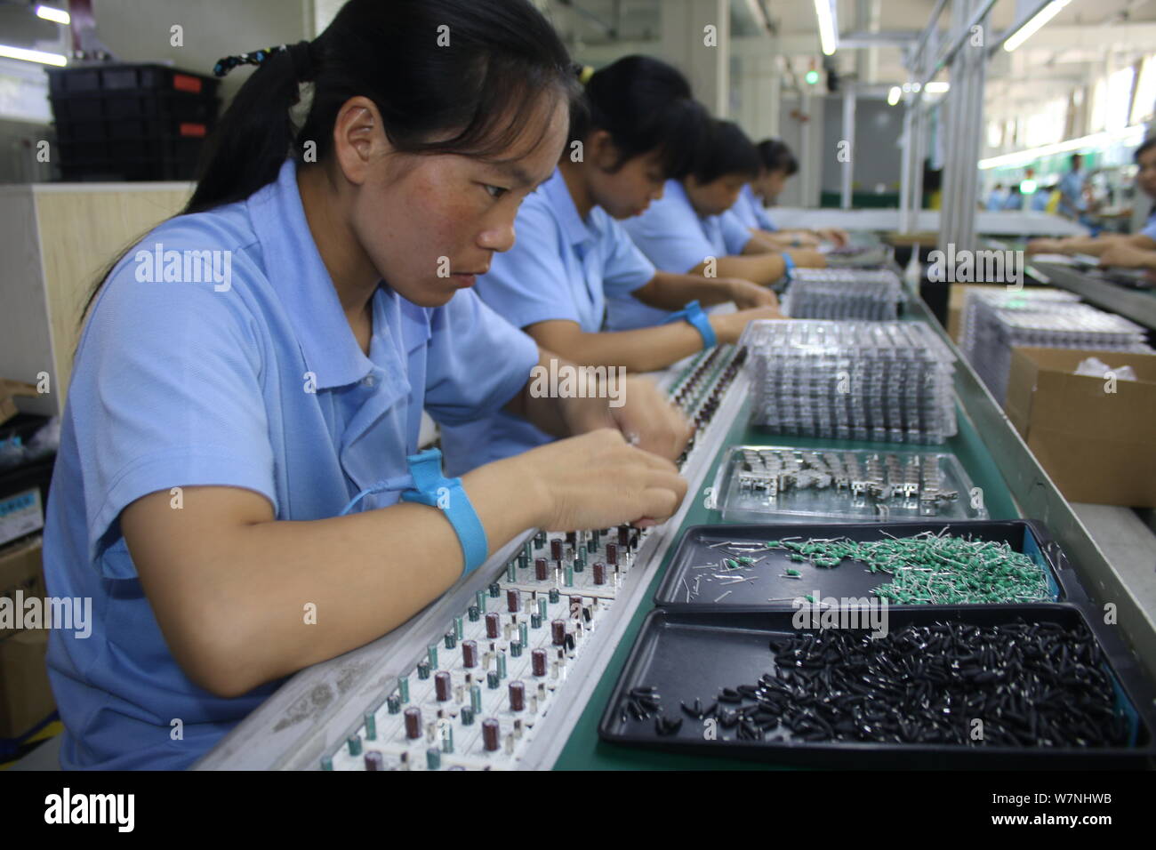 --FILE--Female Chinese workers produce electronic products on the ...