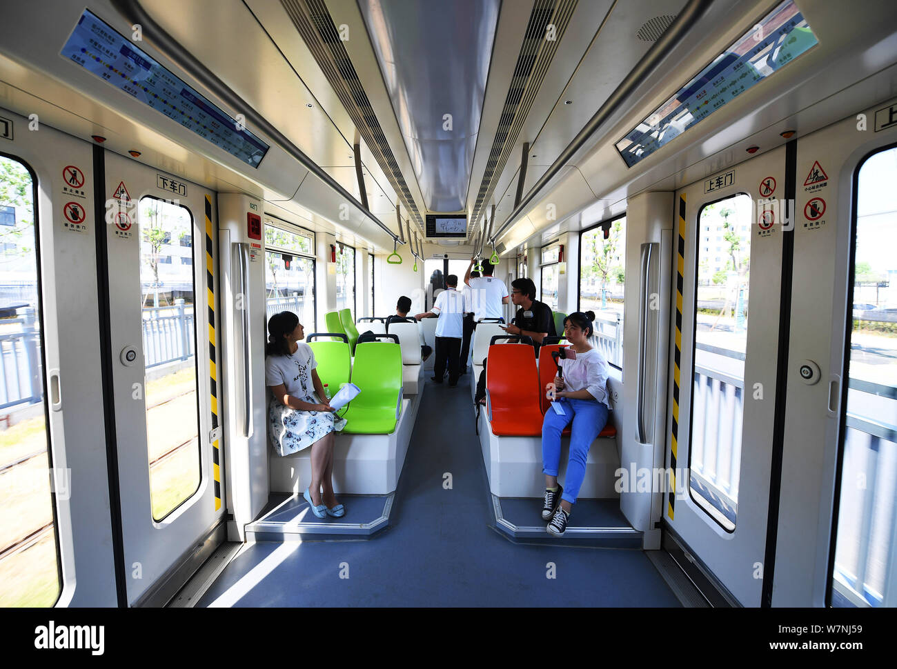 Passengers are seen in a tramcar on the city's first tram line in Wuhan ...