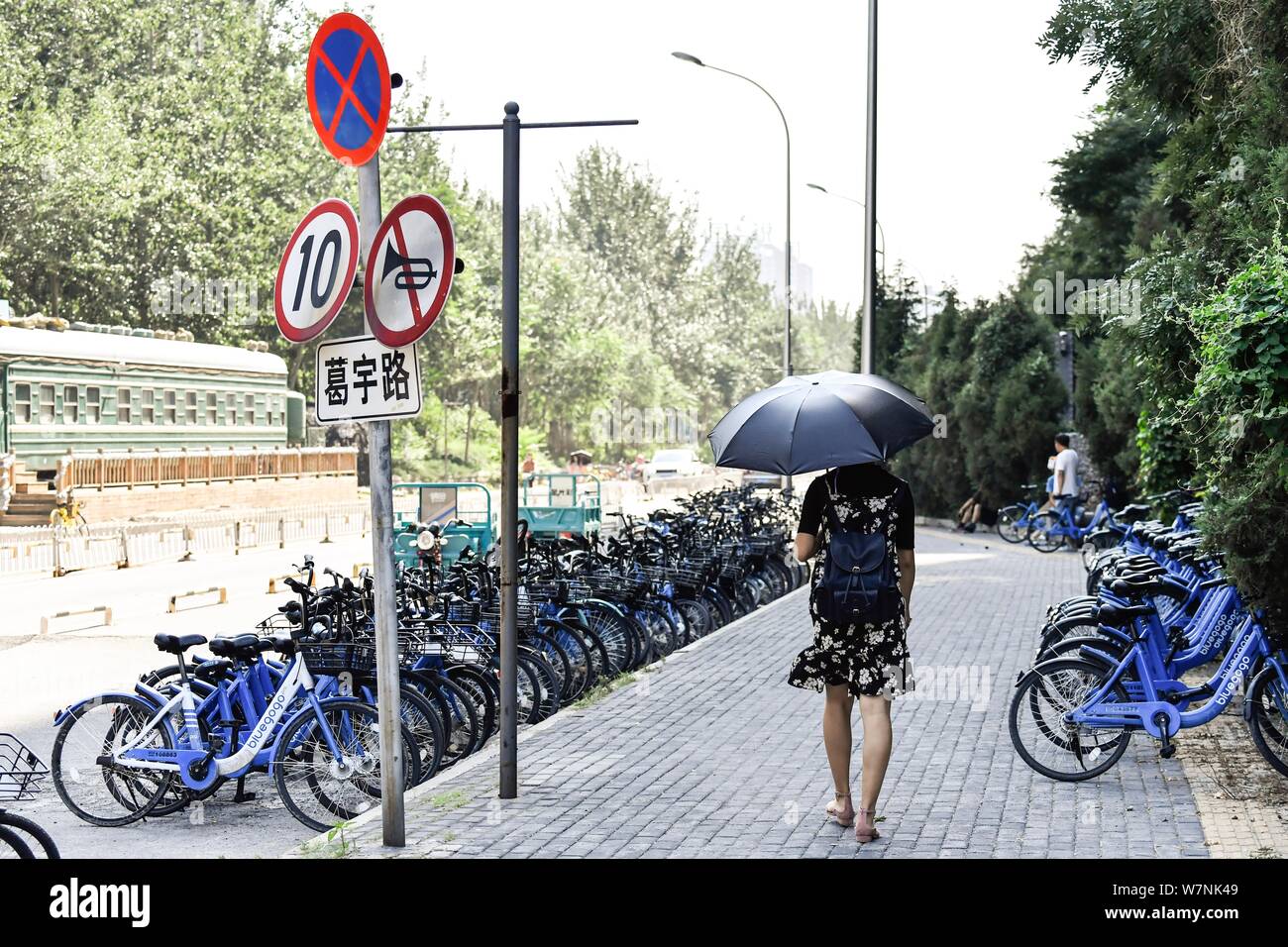 A pedestrian walks past a homemade guideboard "Geyu Road" installed by ...