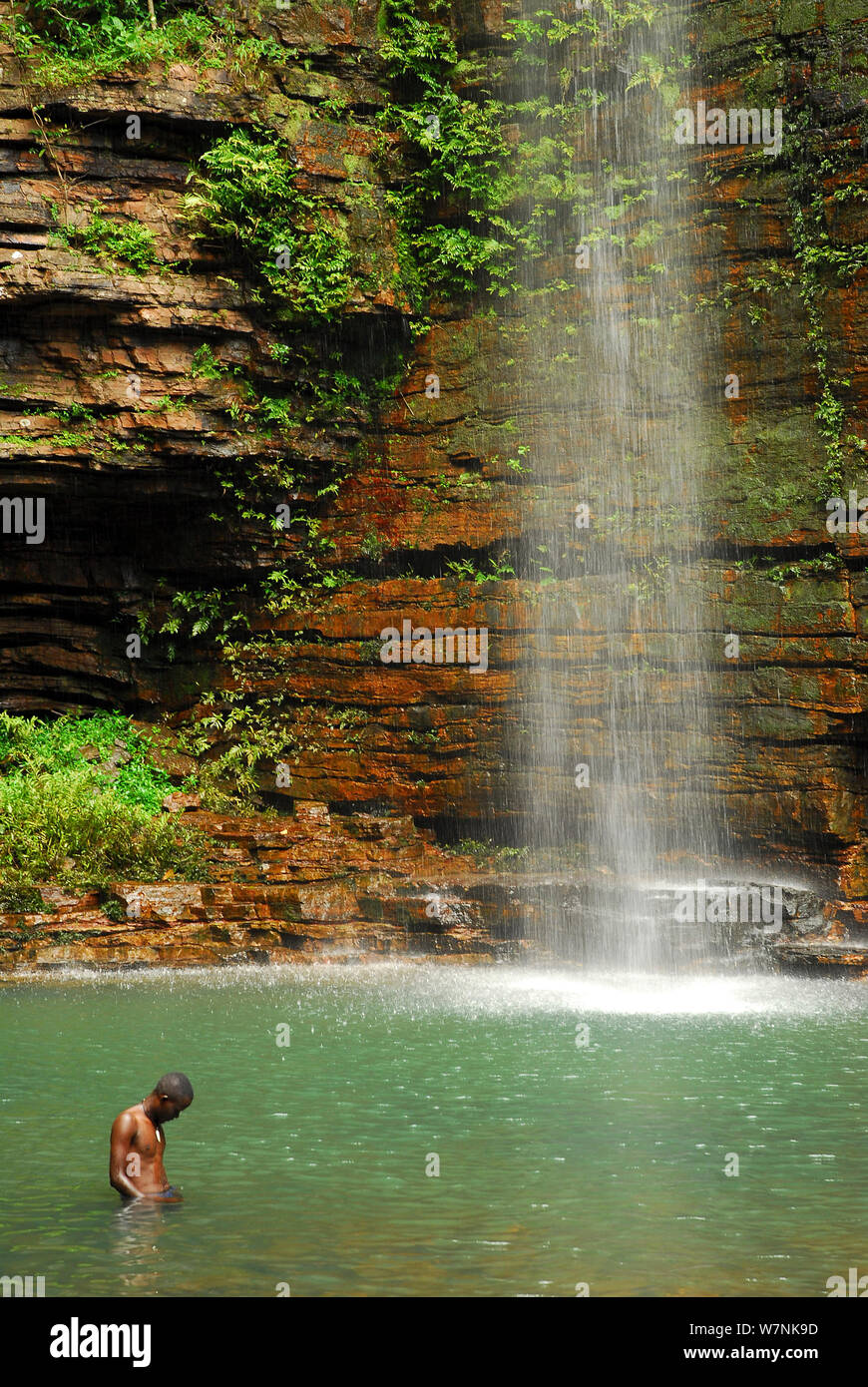 Man in the water by Dindefelo waterfall. Bassari country, east Senegal ...