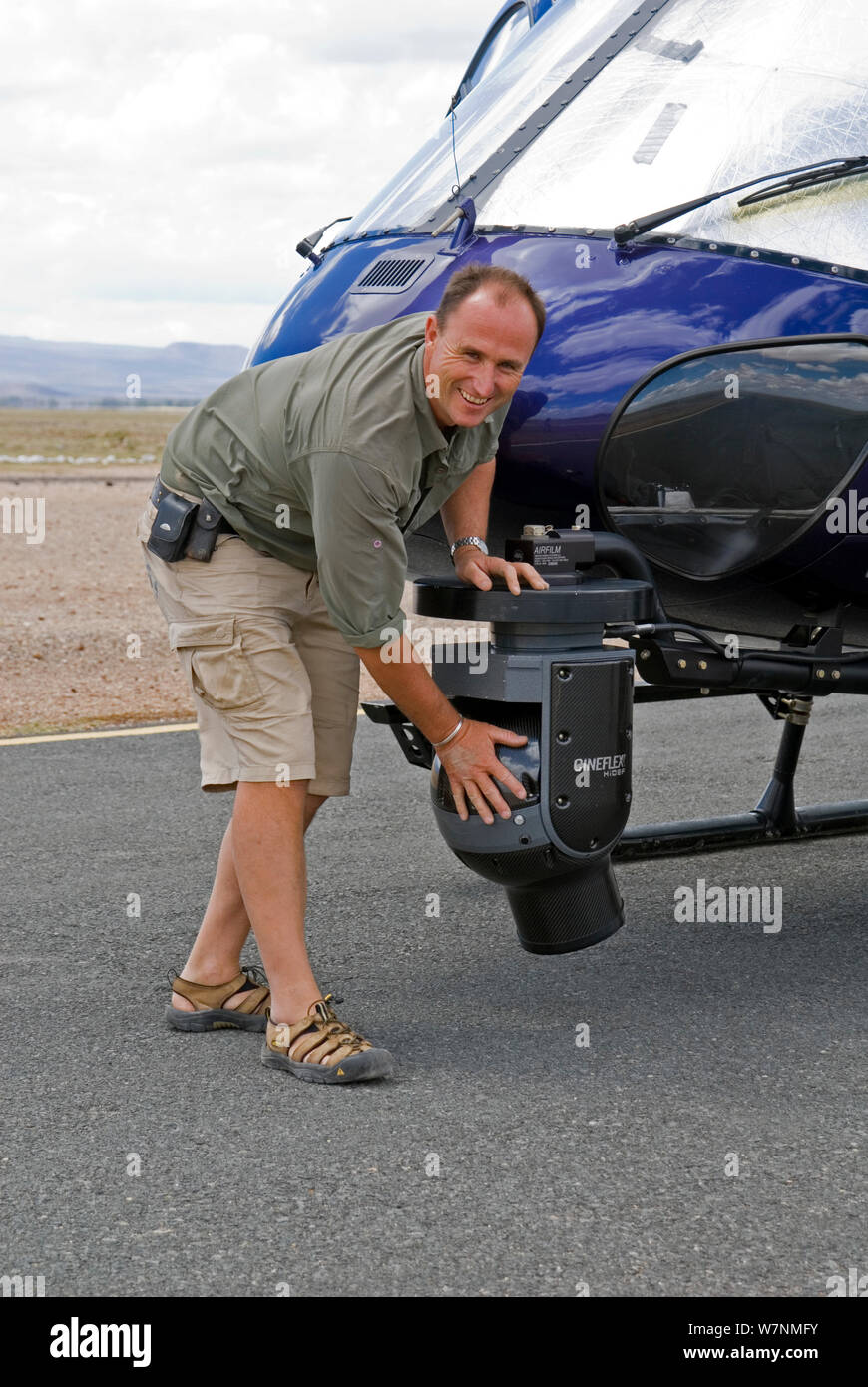 Cameraman Martyn Colbeck with mounted Cineflex camera on helicopter ...