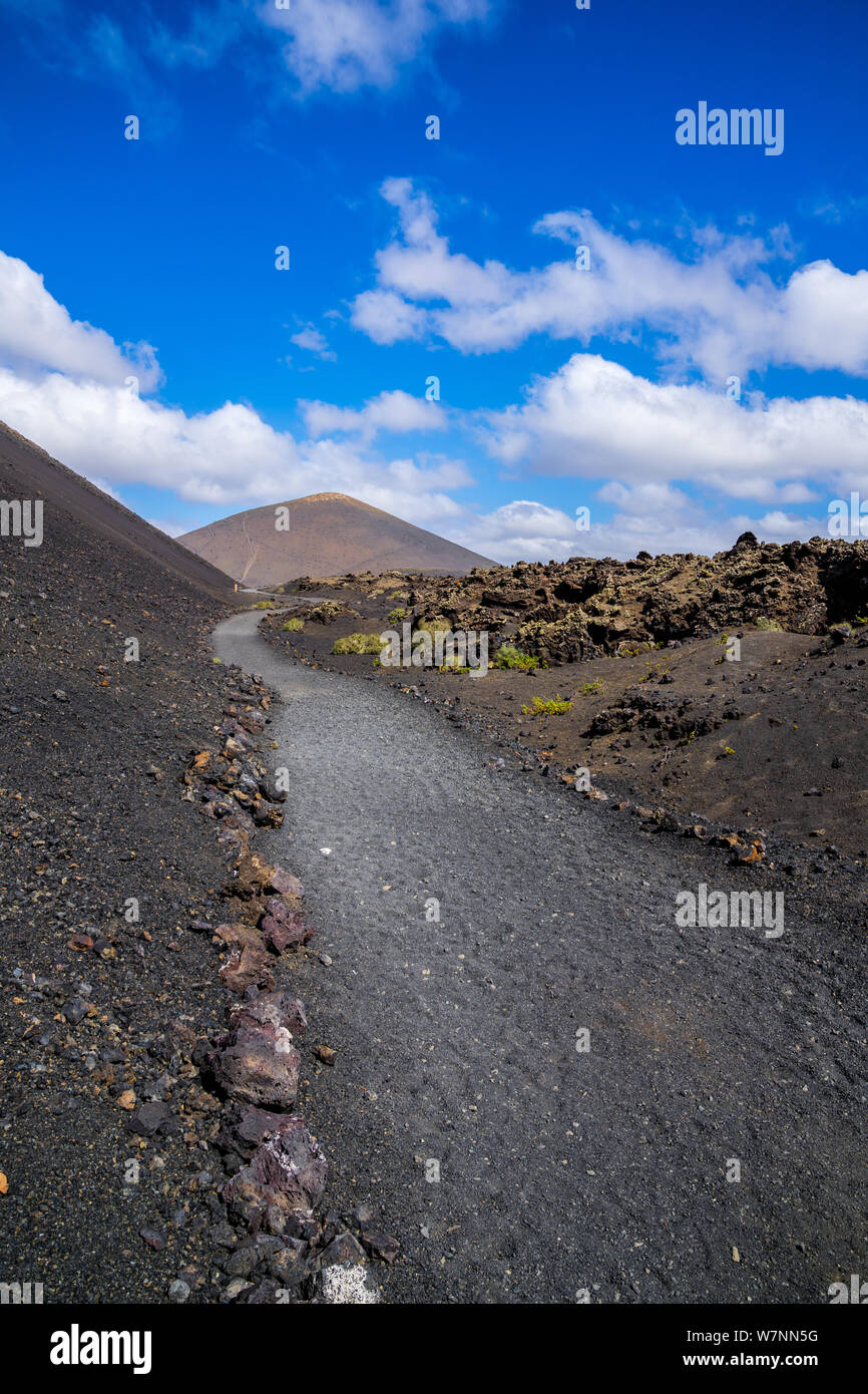 Spain, Lanzarote, Beautiful walking path alongside majestic volcano el ...