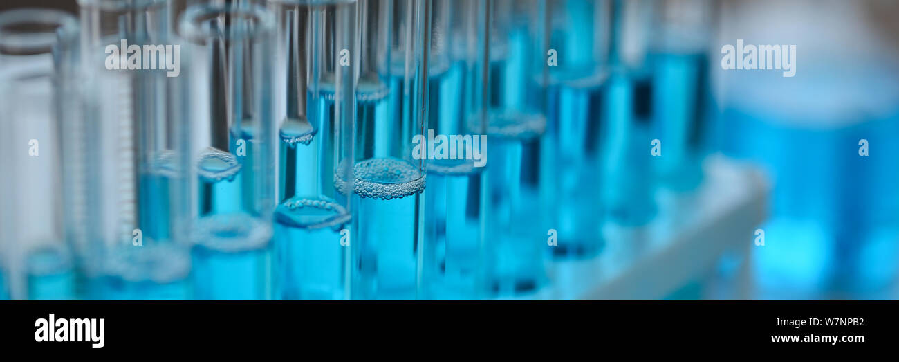 Test tube of glass overflows liquid solution potassium Stock Photo - Alamy