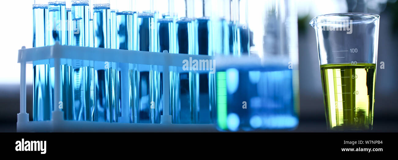 Test tube of glass overflows liquid solution potassium Stock Photo - Alamy