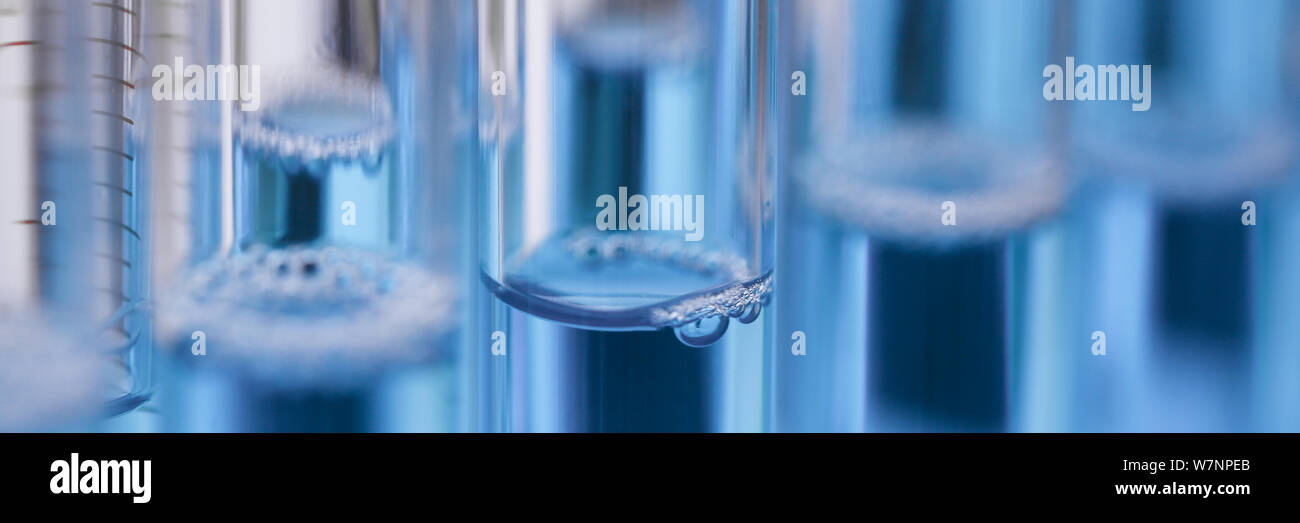 Test tube of glass overflows liquid solution potassium Stock Photo - Alamy
