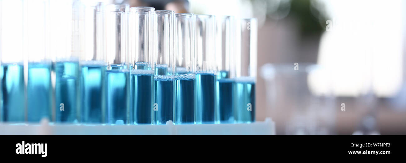 Test tube of glass overflows liquid solution potassium Stock Photo - Alamy