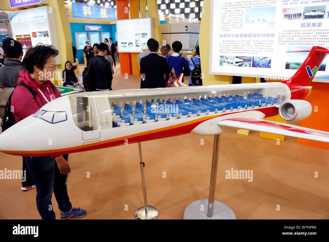--FILE--Visitors look at a model of the ARJ21 regional jet of COMAC ...