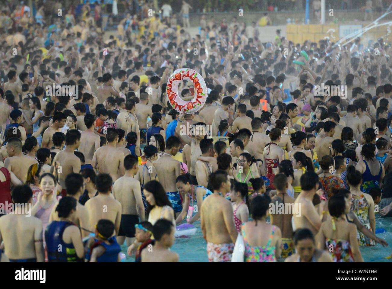 Chinese holidaymakers crowd a swimming pool at a water park in Wuhan ...