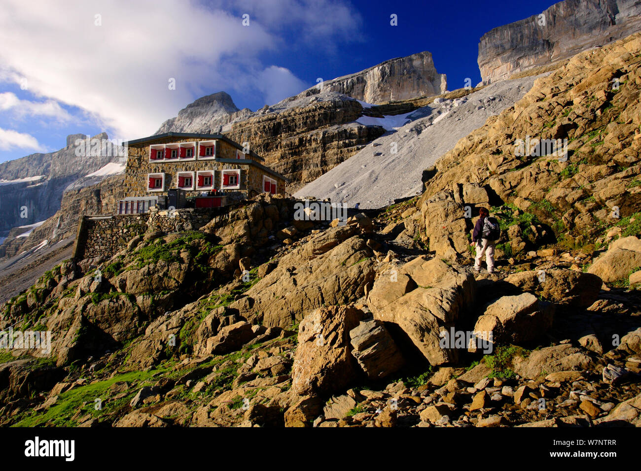 Hiker climbing to la Breche mountain hut below la Breche de Roland, Luz ...