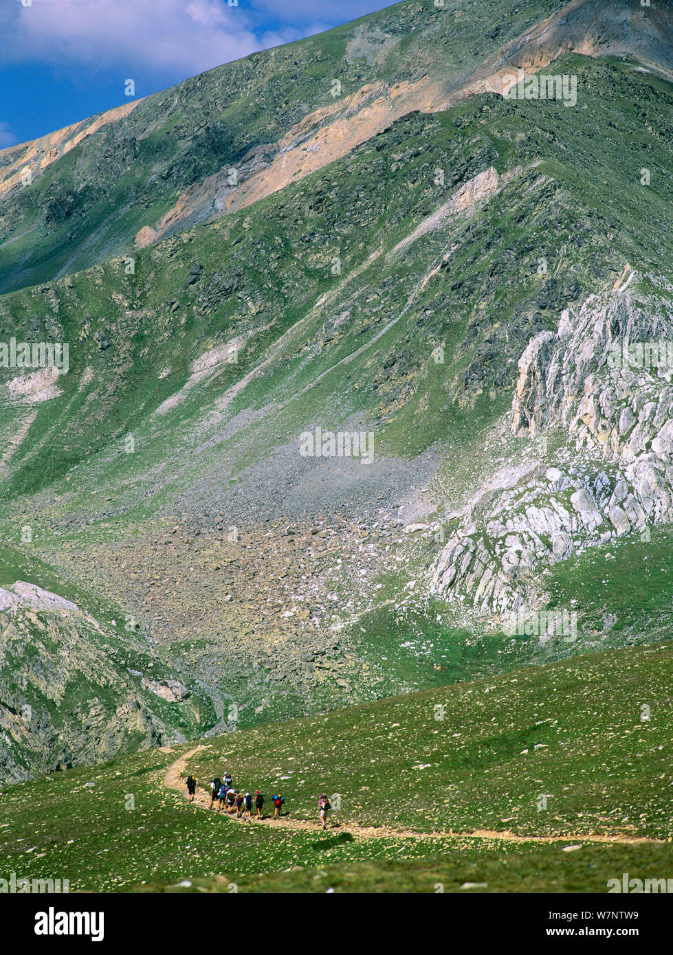 Mountain walkers below Bastiments peak (2881 m) walking the Nuria ...