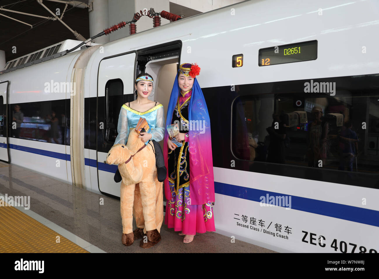 Chinese artists dressed in traditional costumes of different ethnic ...