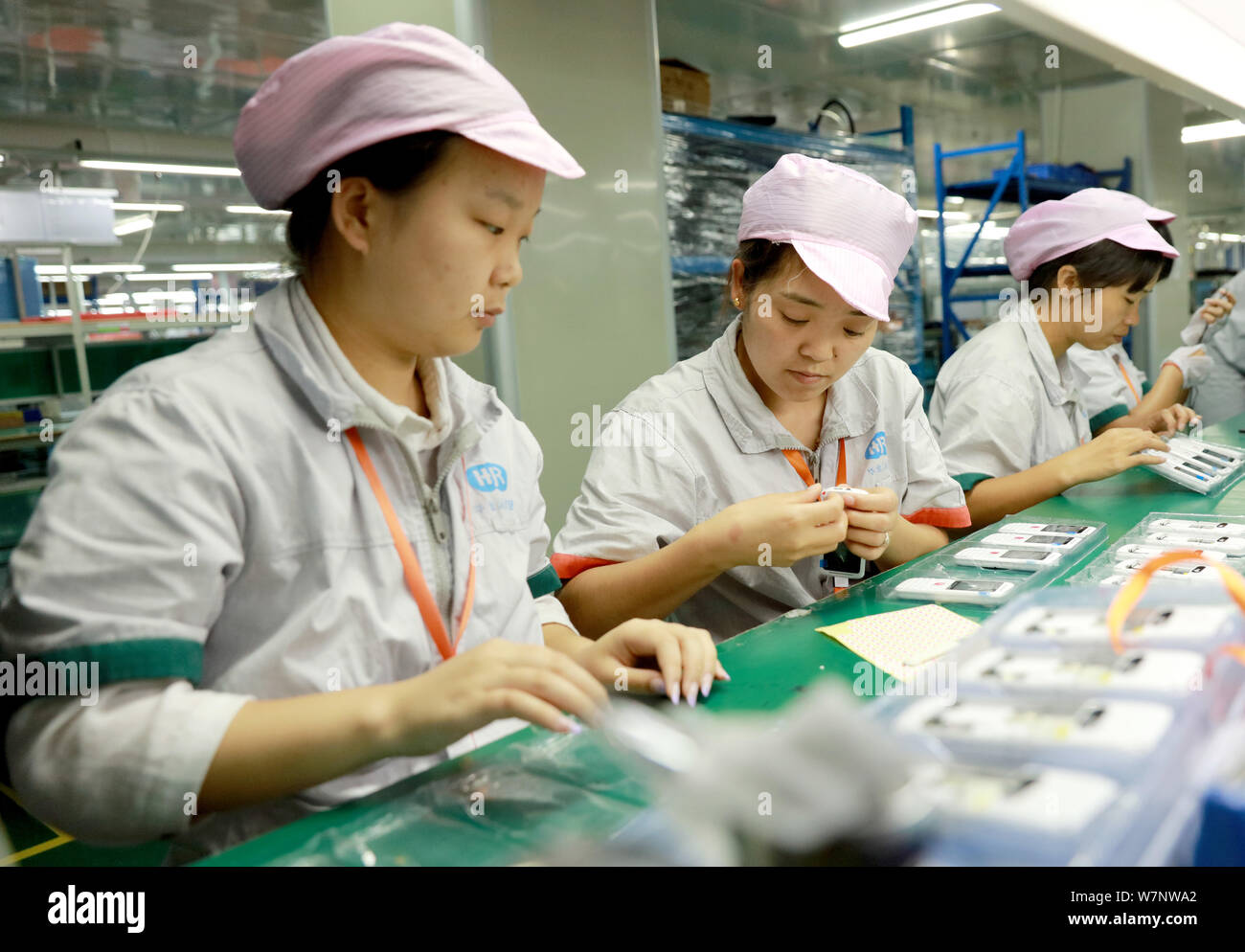 --FILE--Female Chinese workers produce electronic products on the assembly line at a factory in ...