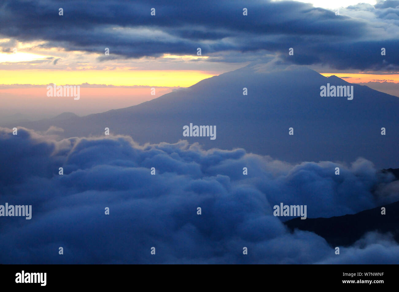 Dusk and clouds on Mount Kilimanjaro with Mount Meru in background ...