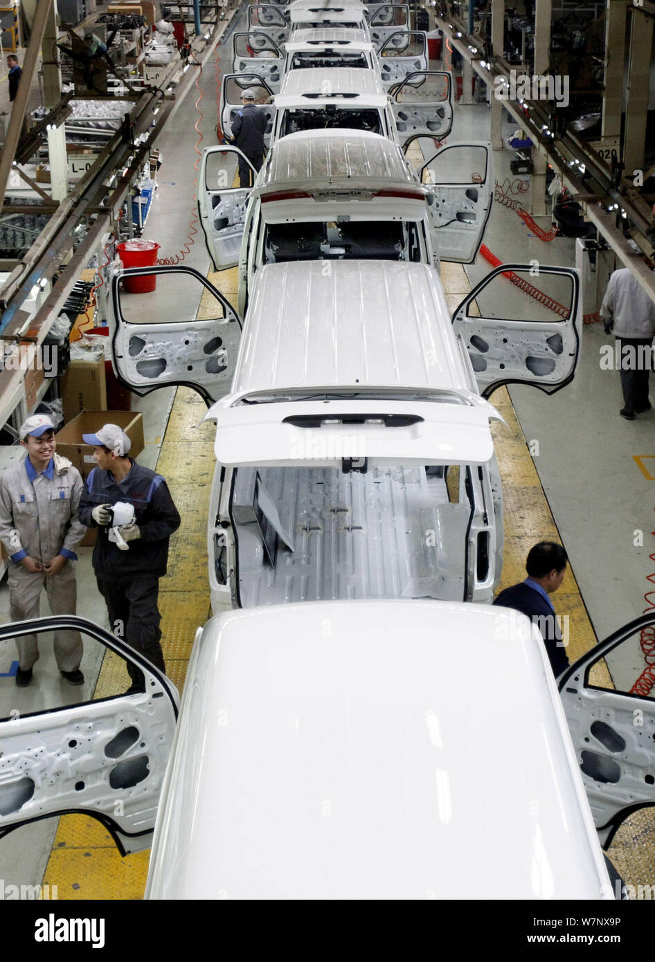 --FILE--Chinese workers assemble vans on the assembly line at the plant ...