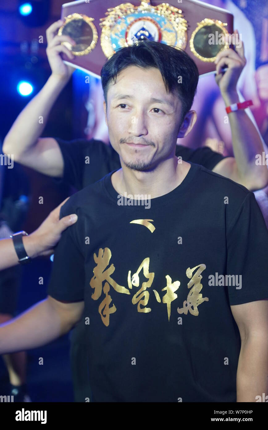 Chinese boxing star Zou Shiming is interviewed at a weighing ceremony ...