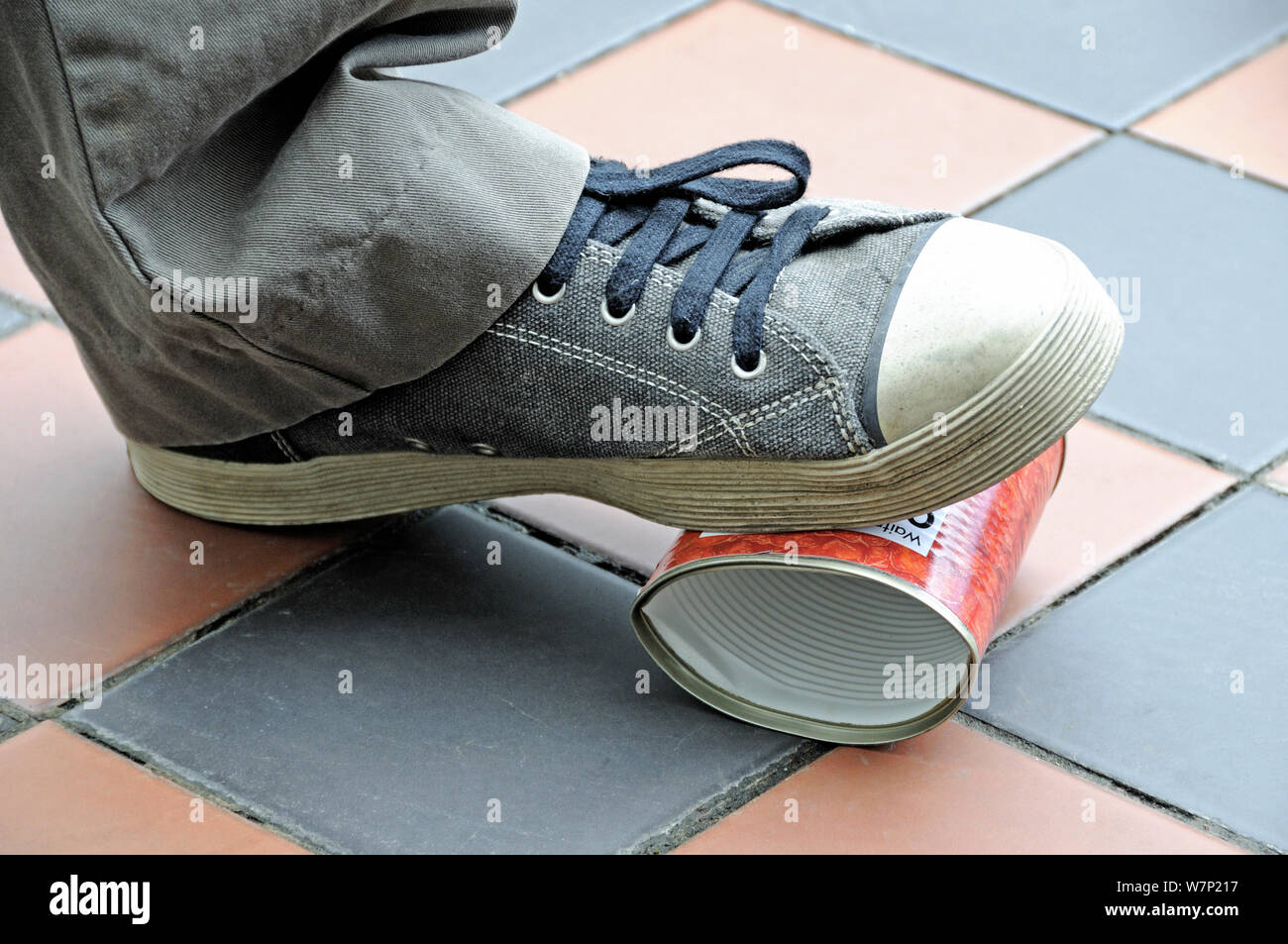 Foot crushing can before recycling, so that no small creature will be ...