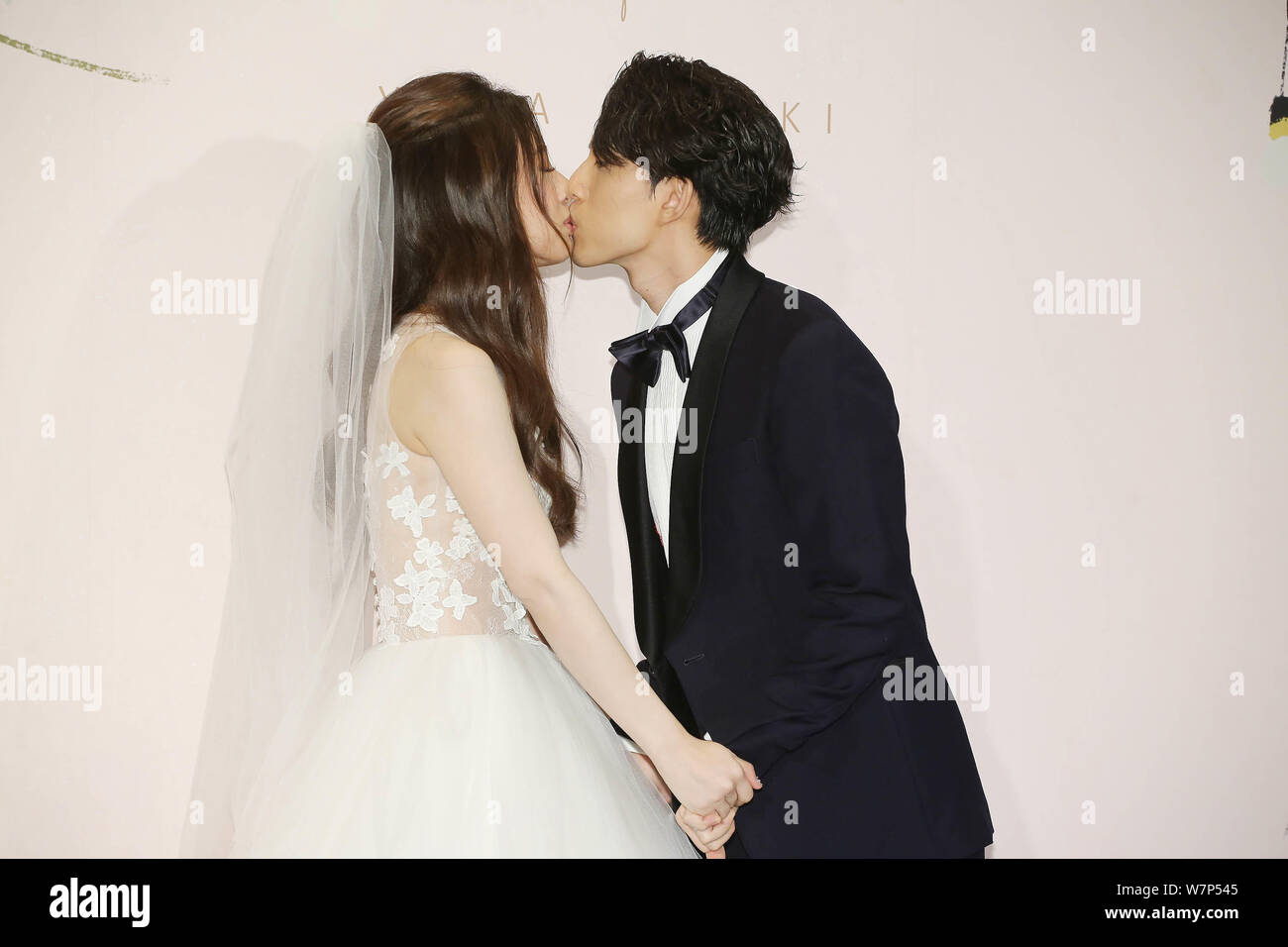 **TAIWAN OUT**Taiwanese singer Yoga Lin, right, kisses his singer wife ...