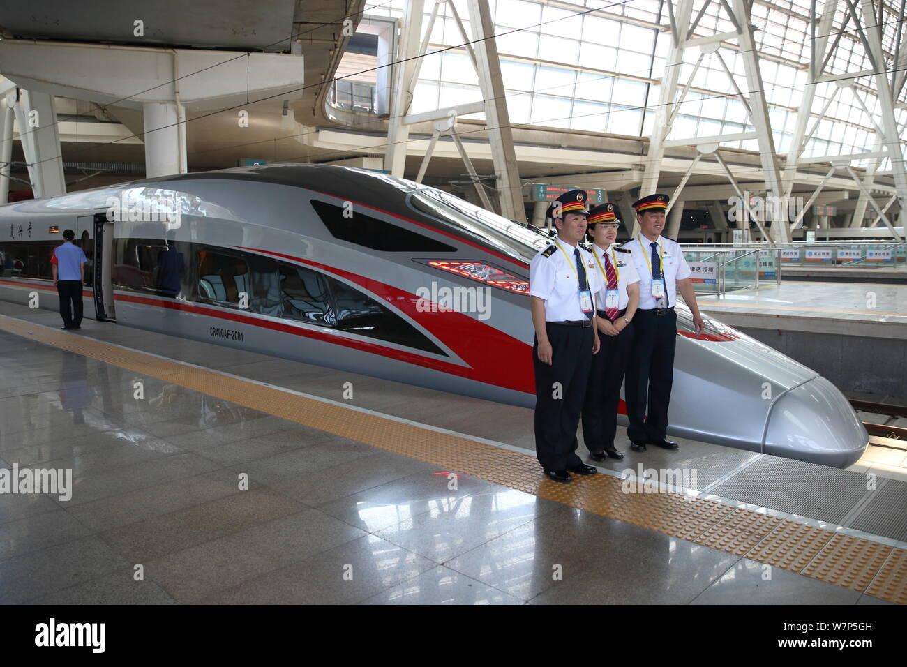 Drivers pose in front of a "Fuxing" high speed bullet train on Beijing ...