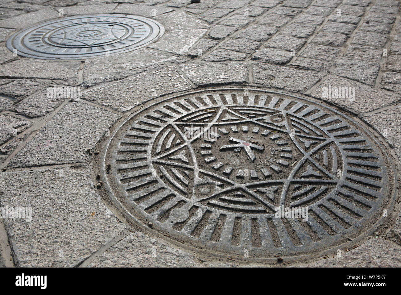 View of sewer manhole covers, derived from the German's gullies, on a ...