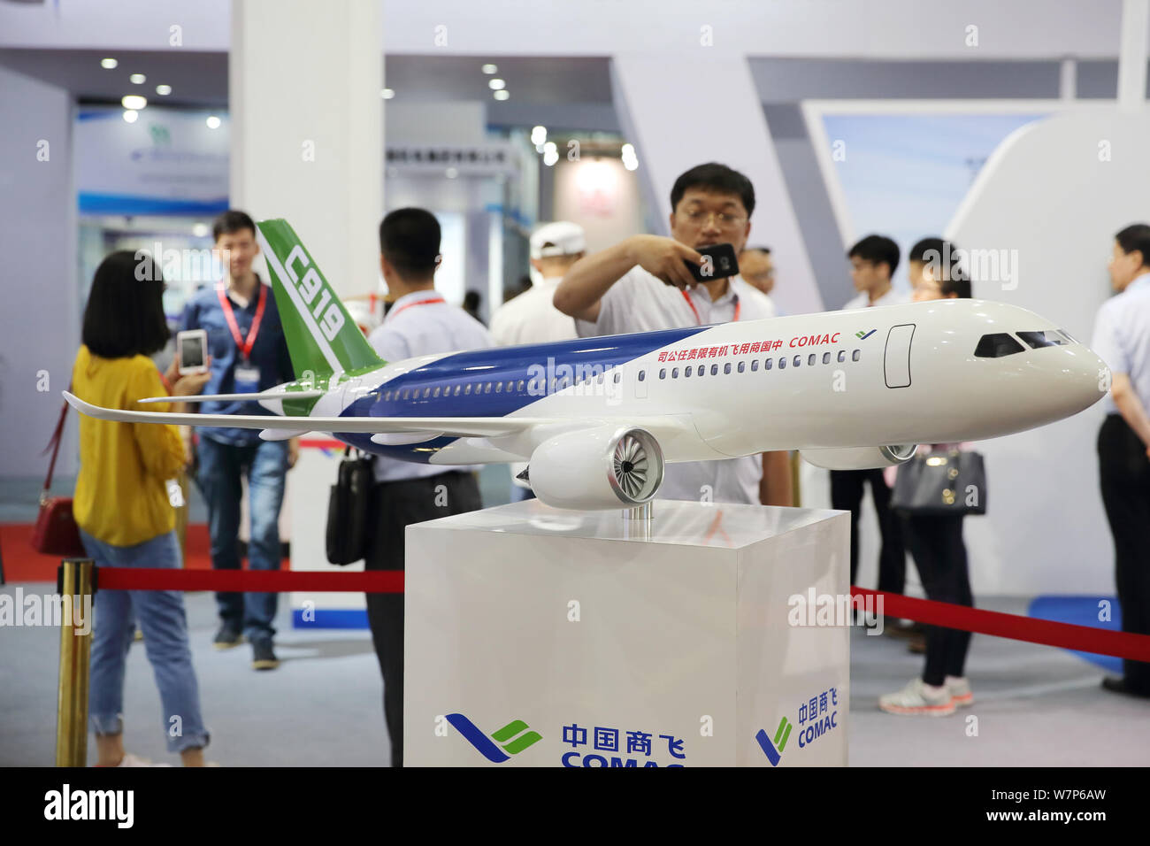 Visitors take photos of a model of China's first large passenger jet ...