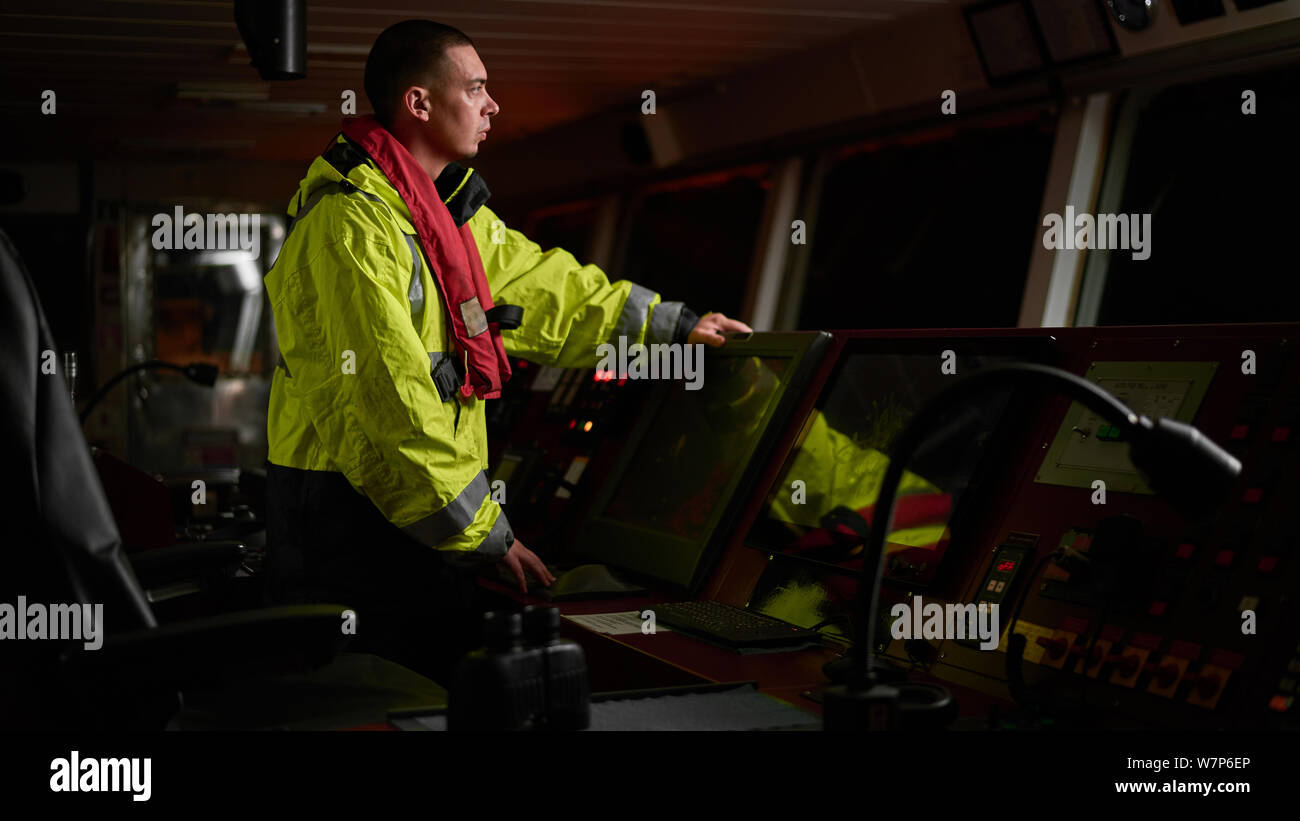 Navigator. pilot, captain as part of ship crew performing daily duties ...