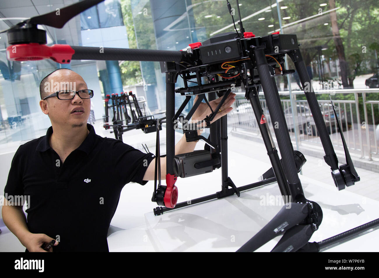 A Chinese visitor looks at a drone on display at the headquarters of ...