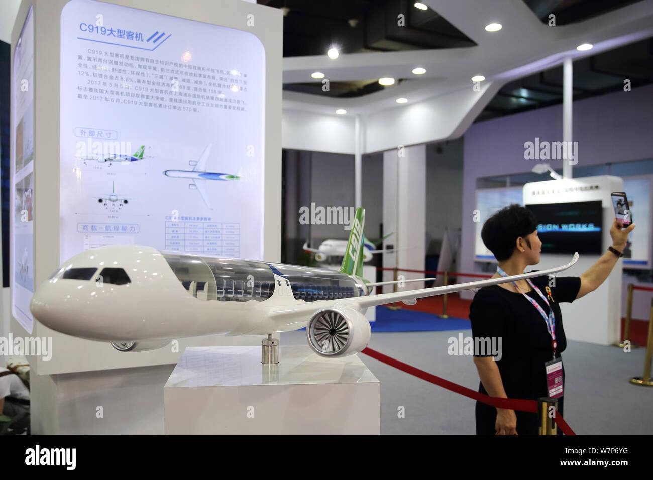 A visitor takes photos of a model of China's first large passenger jet ...
